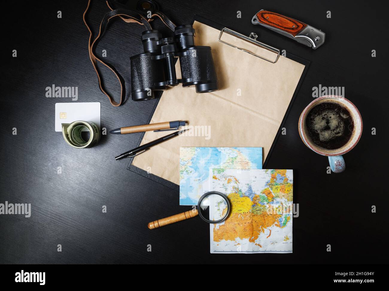 Planning vacation trip. Traveler's accessories on black table ...