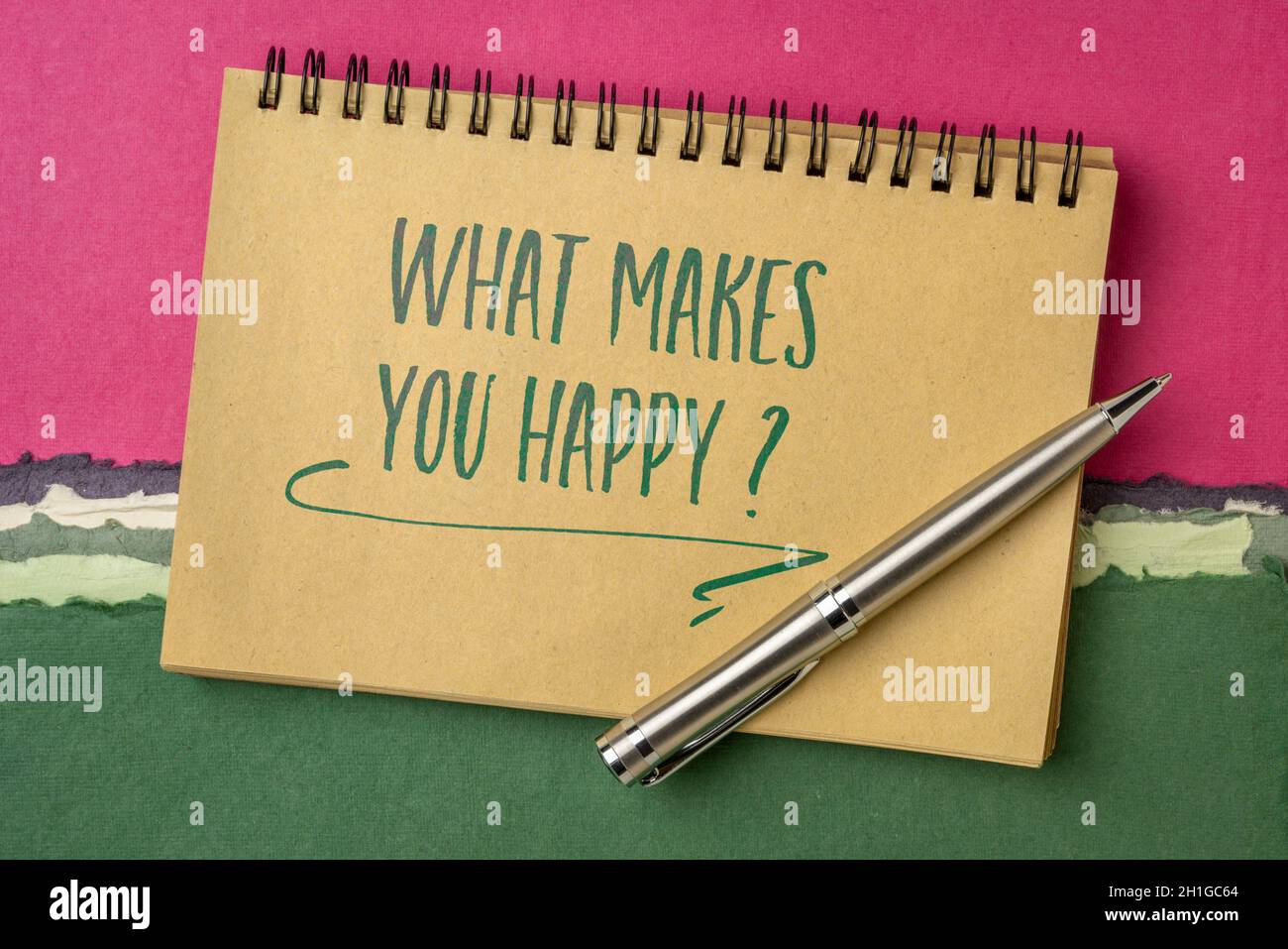 What makes you happy? A question handwritten in a notebook against ...
