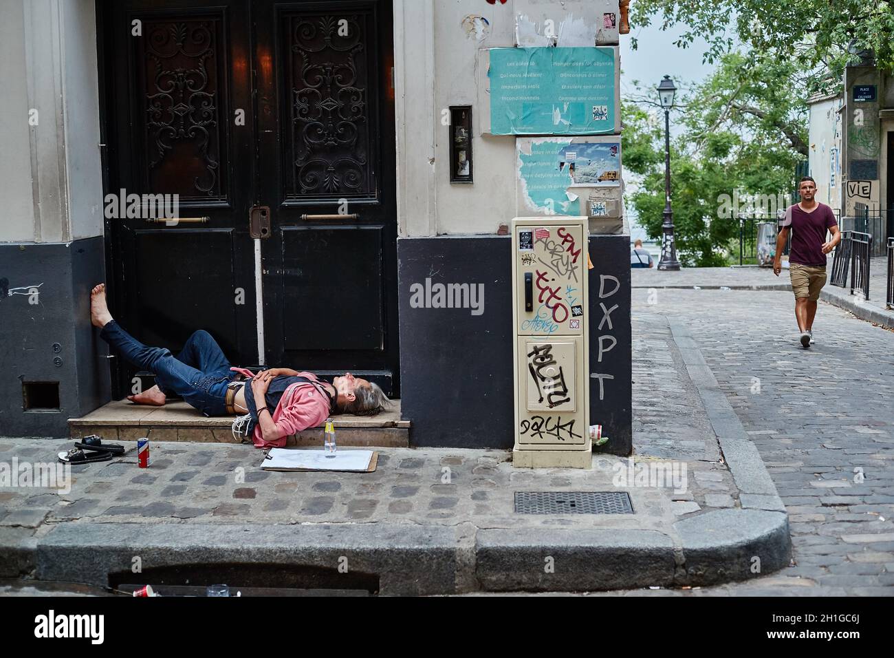 Paris, France - July 2019: An old french woman is sleeping on a ...