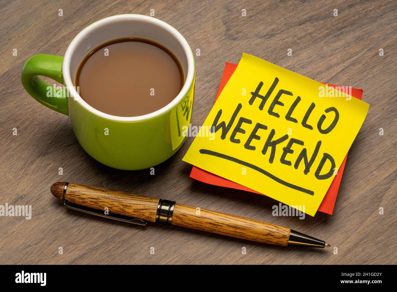 hello weekend - handwriting on a sticky note with a cup of coffee ...