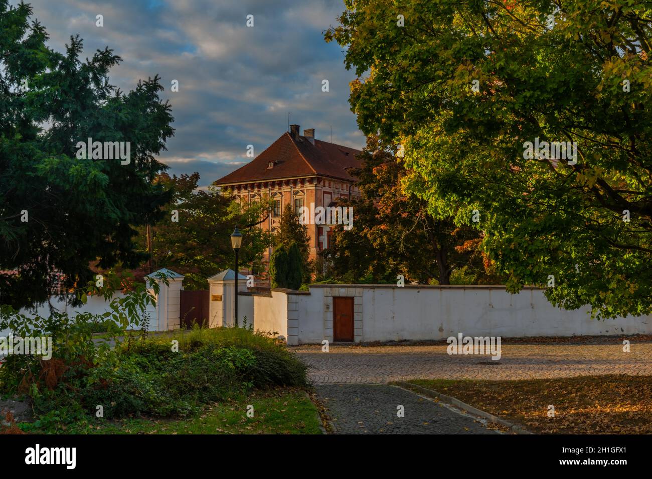 Orange sunset in Roudnice nad Labem town with old church and towers ...