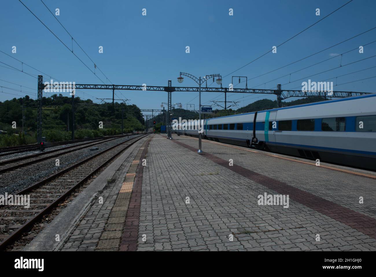 High-speed train passing quickly through the platform of the train ...