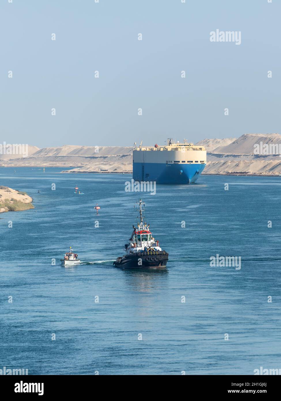 El Qantara, Egypt - November 14, 2019: Tugboat accompanies the ships. Ships passing through the ...