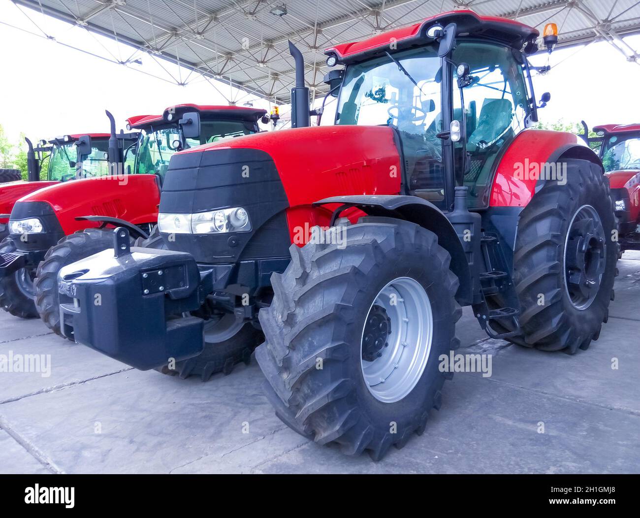 The colorful red tractors. The agriculture, farming concept Stock Photo ...