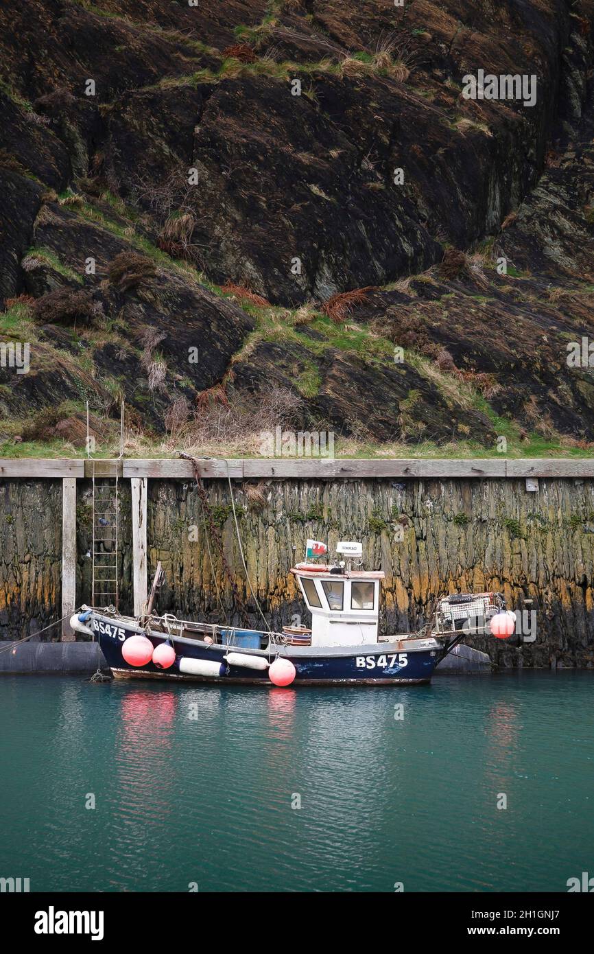 ANGLESEY, UK - February 28, 2012. Small fishing boats shelters in a ...