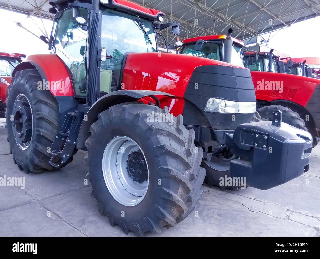 The colorful red tractors. The agriculture, farming concept Stock Photo ...