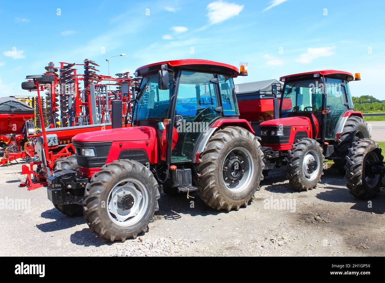 The colorful red tractors. The agriculture, farming concept Stock Photo ...