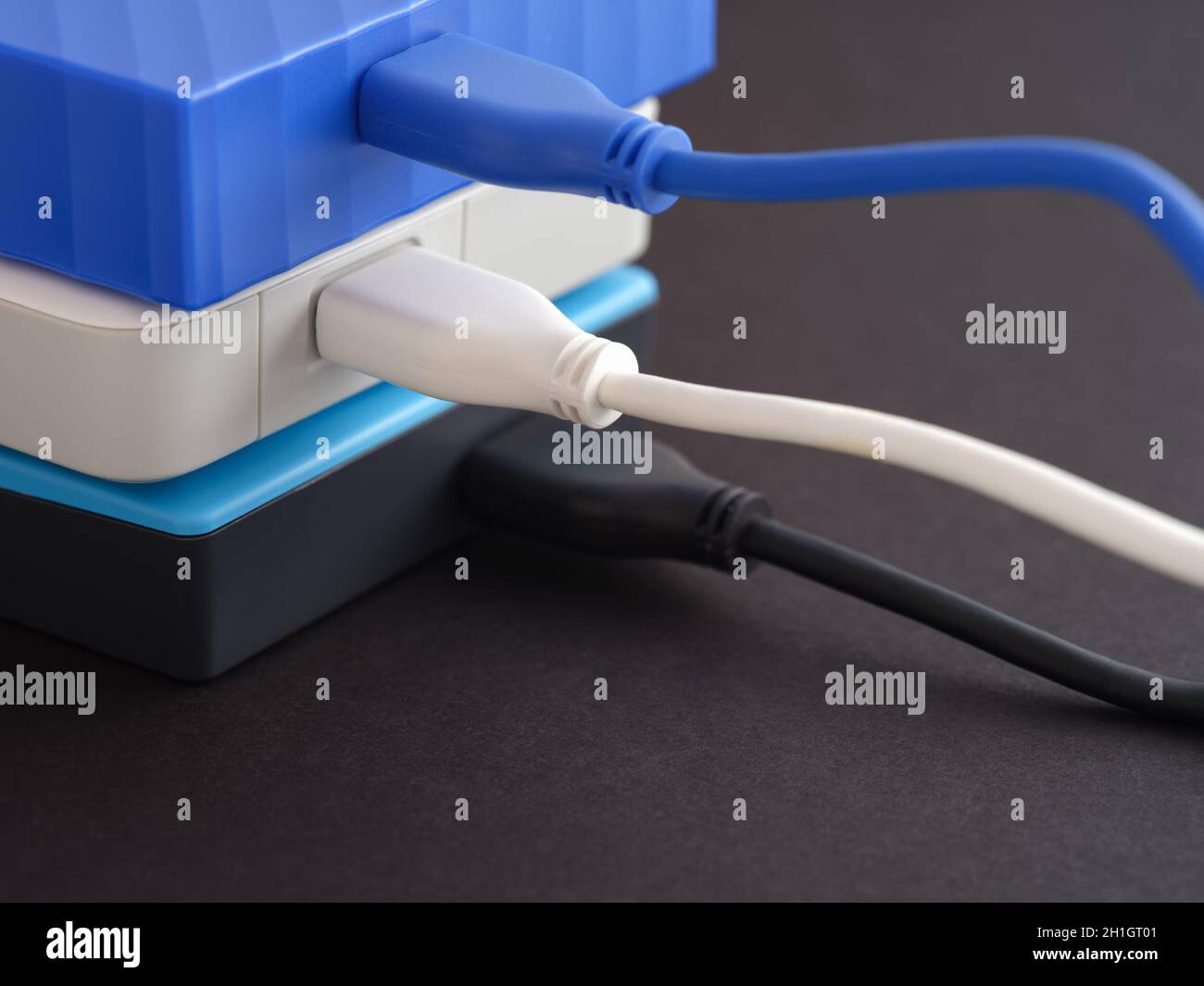 A stack of hard drives. Black background. Close up Stock Photo - Alamy