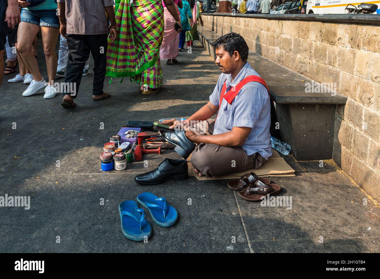 Mumbai, India - November 22, 2019: Poor shoe shiner siting on the floor ...