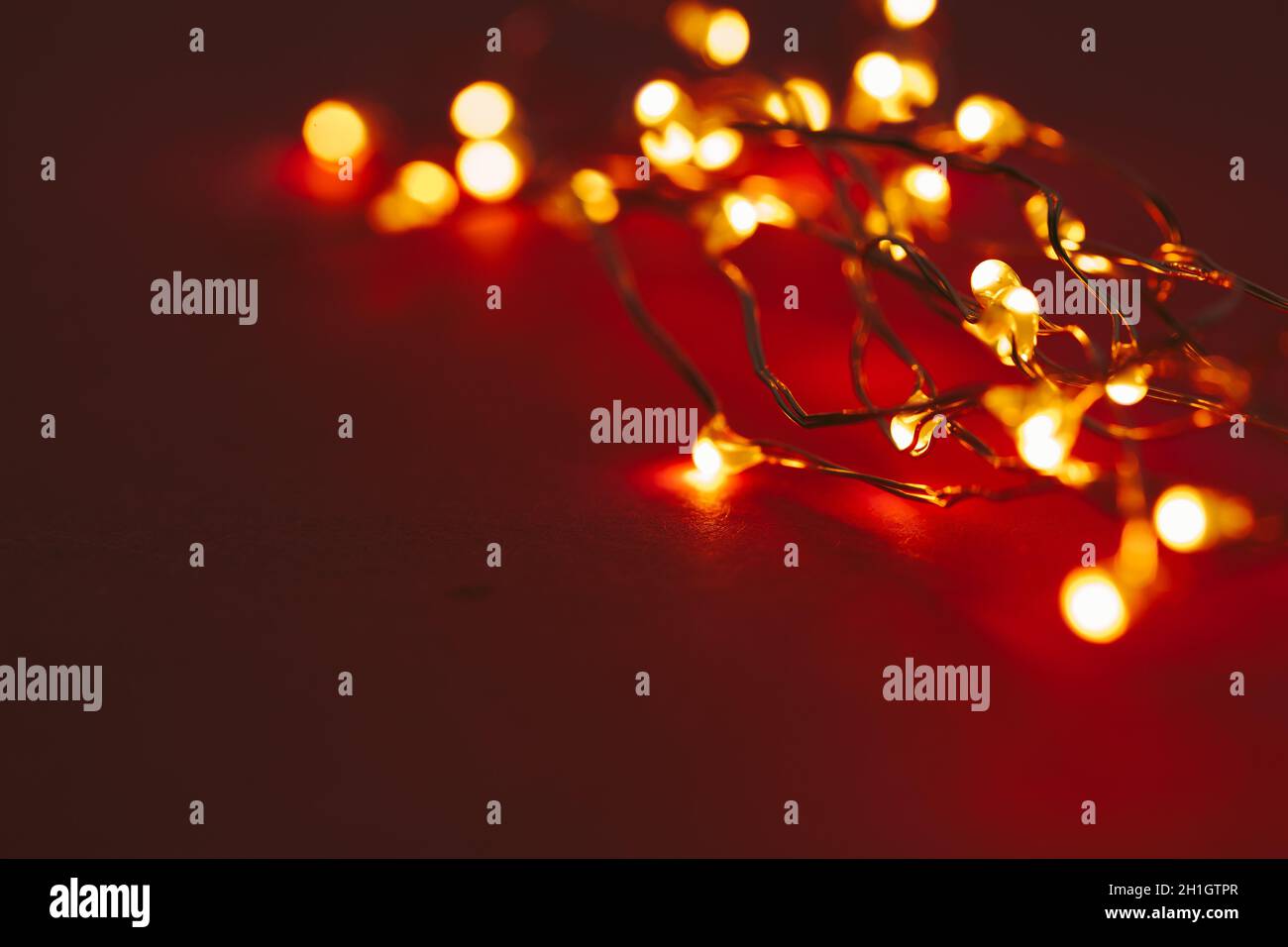 Red background with illuminated lights of garland Stock Photo - Alamy