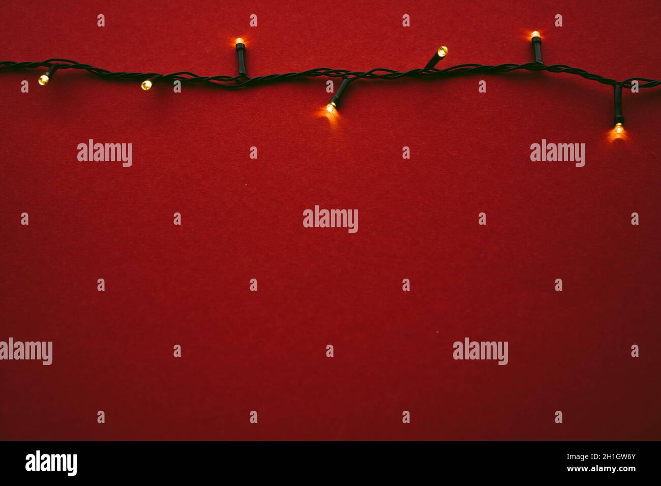 Red background with illuminated lights of garland Stock Photo - Alamy