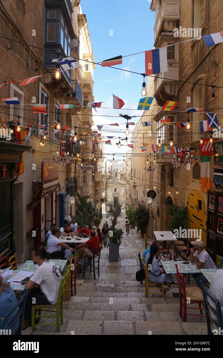 narrow alley with restaurants in the city of Valletta, Malta. Photo by ...