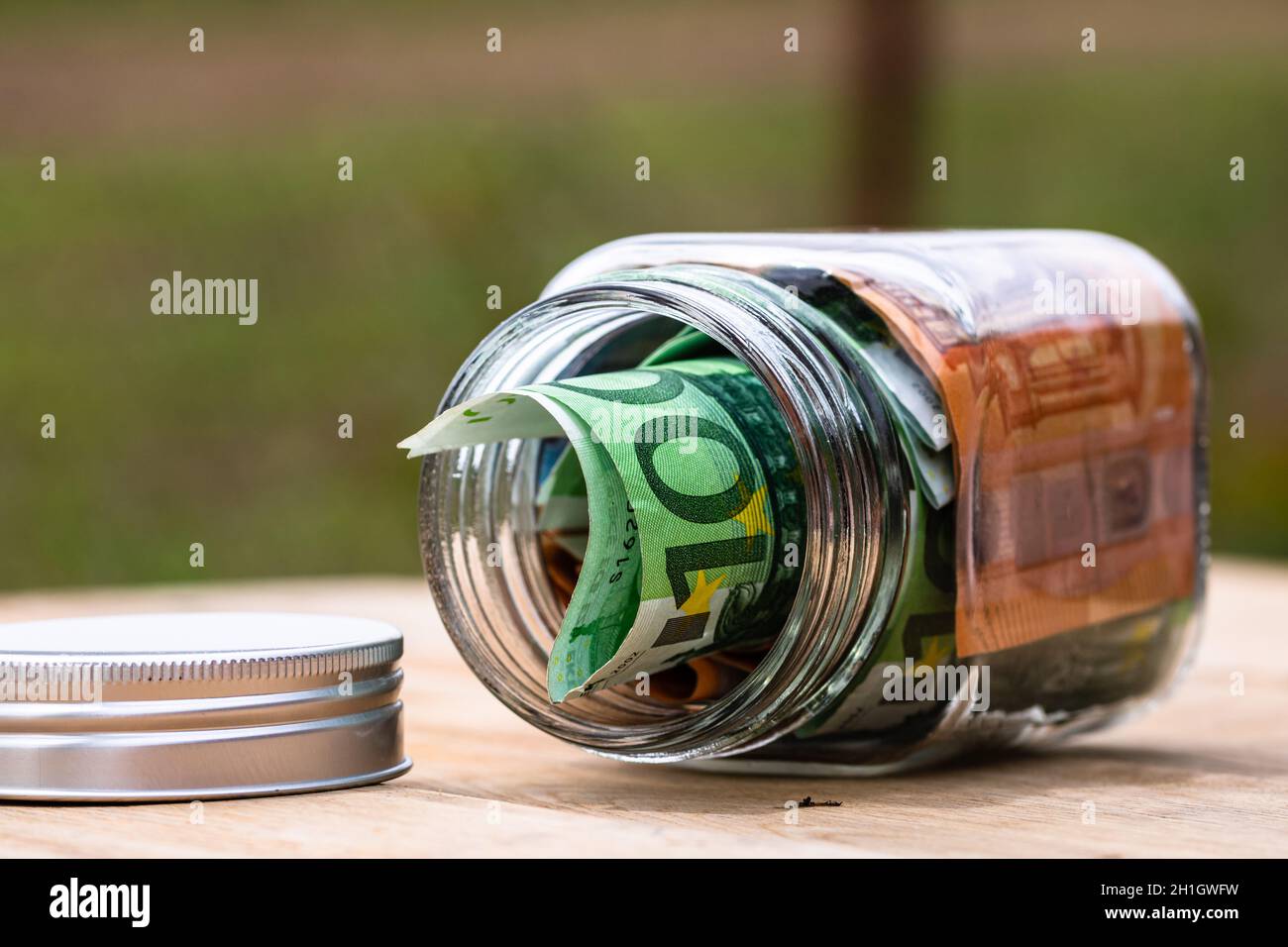 Composition with saving money banknotes in a glass jar. Concept of ...
