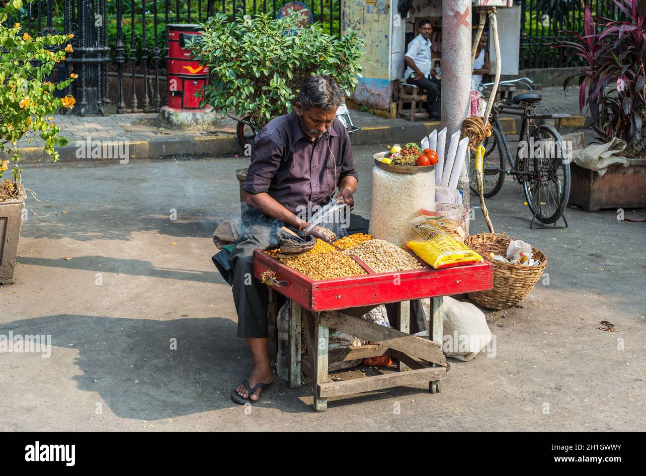 Mumbai, India - November 22, 2019: Indian man selling nuts at a street ...