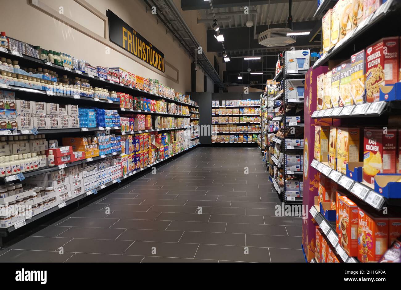 WETZLAR, GERMANY - DEZEMBER 18 2019: Aisle with food products, interior ...