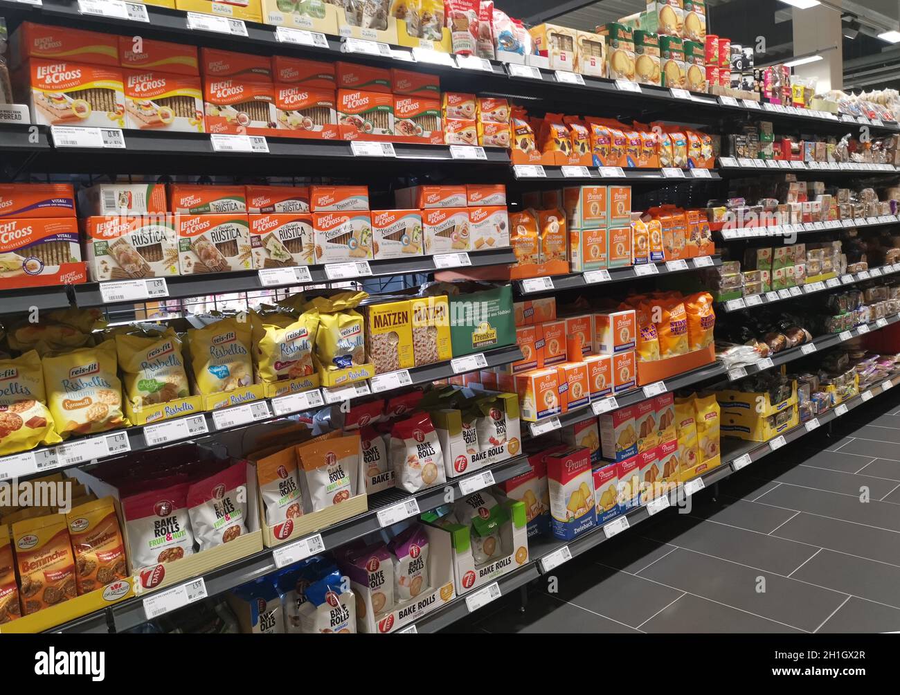 WETZLAR, GERMANY - DEZEMBER 18 2019: Aisle with food products, interior ...