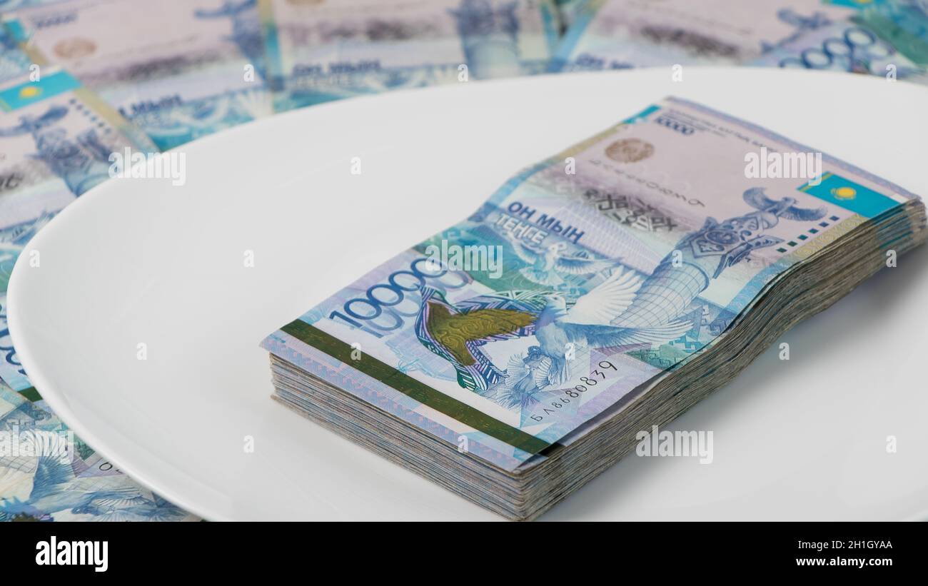 A lot of Kazakhstan tenge in a circle on the table. The national ...