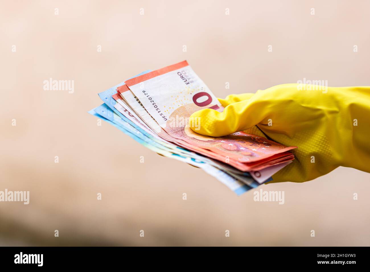Hand with gloves receiving, giving or holding USD EURO banknote. World ...