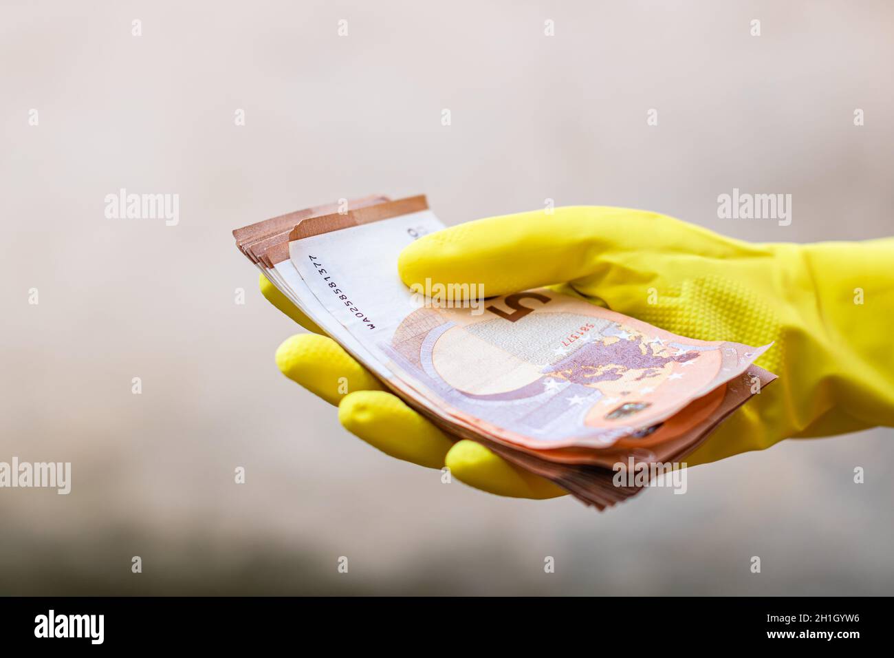 Hand with gloves receiving, giving or holding USD EURO banknote. World ...