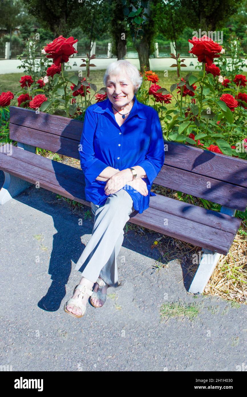 Portrait of a smiling elderly woman. A photo on the nature park ...
