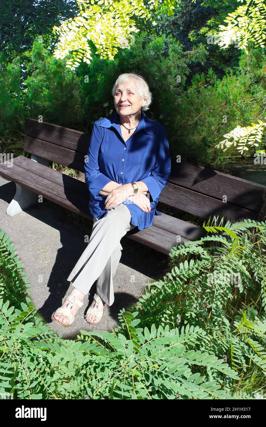 Portrait of a smiling elderly woman. A photo on the nature park ...
