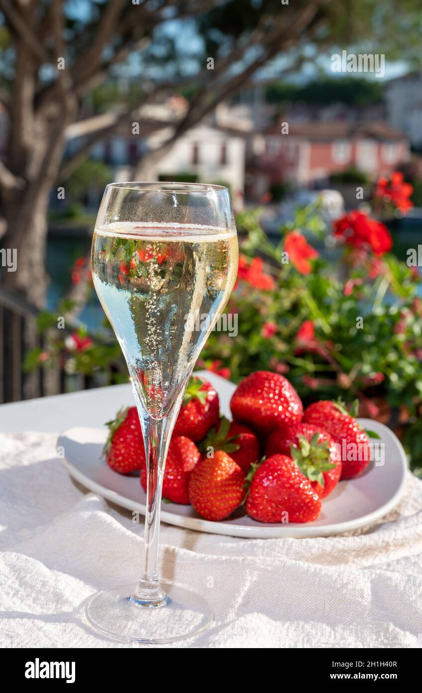 Summer party, pouring of French brut champagne sparkling wine in ...