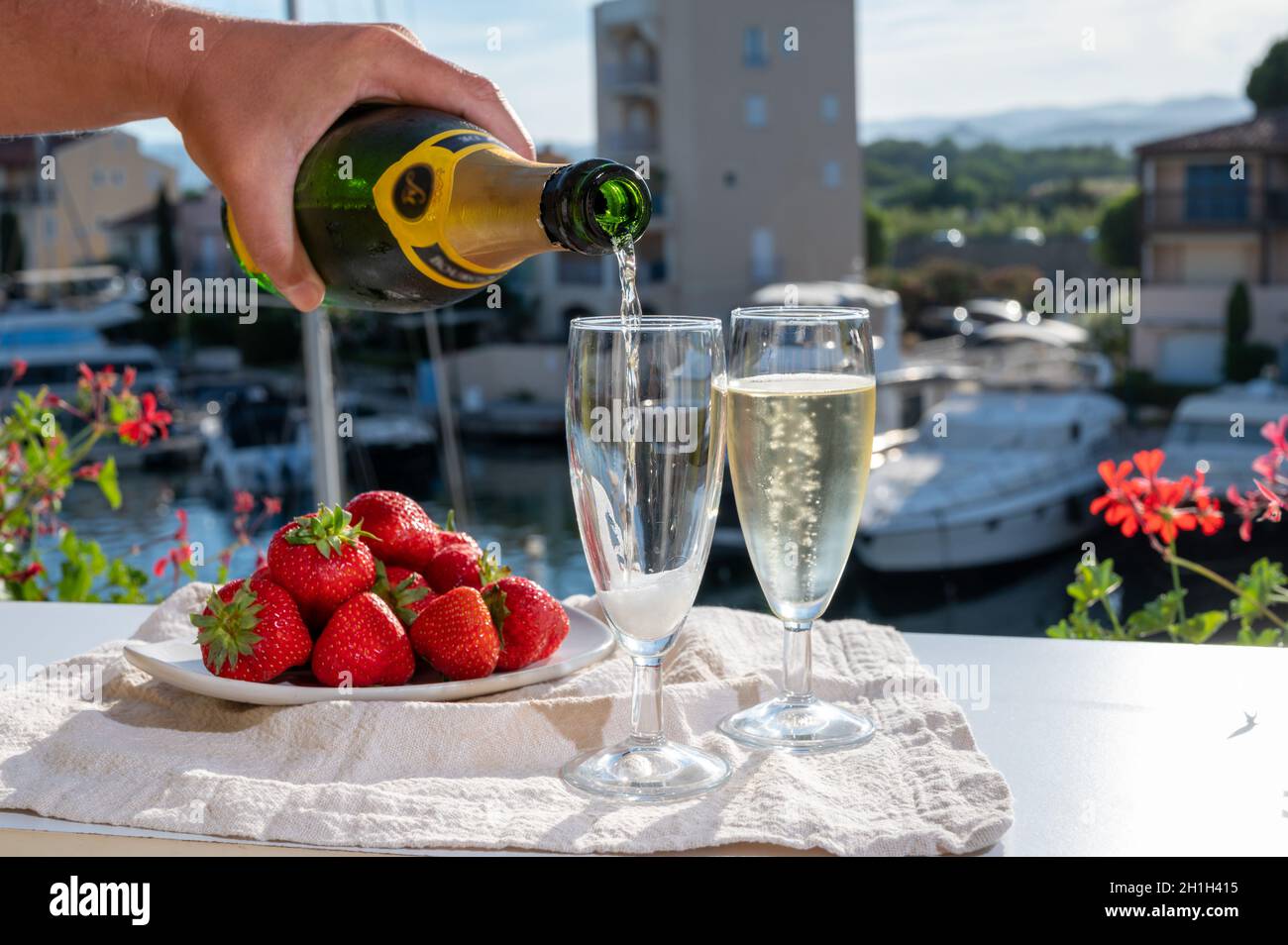 Summer party, pouring of French brut champagne sparkling wine in ...
