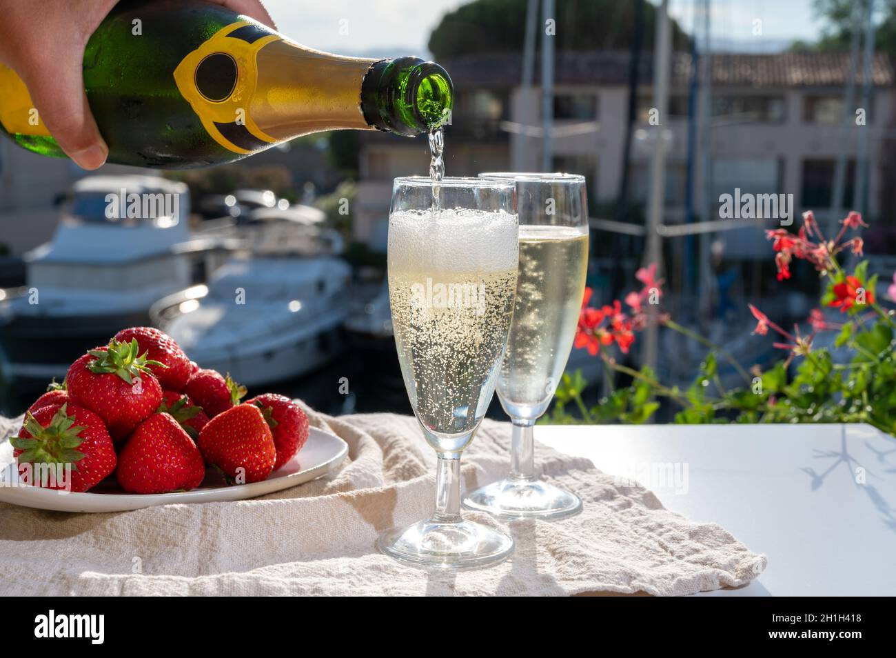 Summer party, pouring of French brut champagne sparkling wine in ...