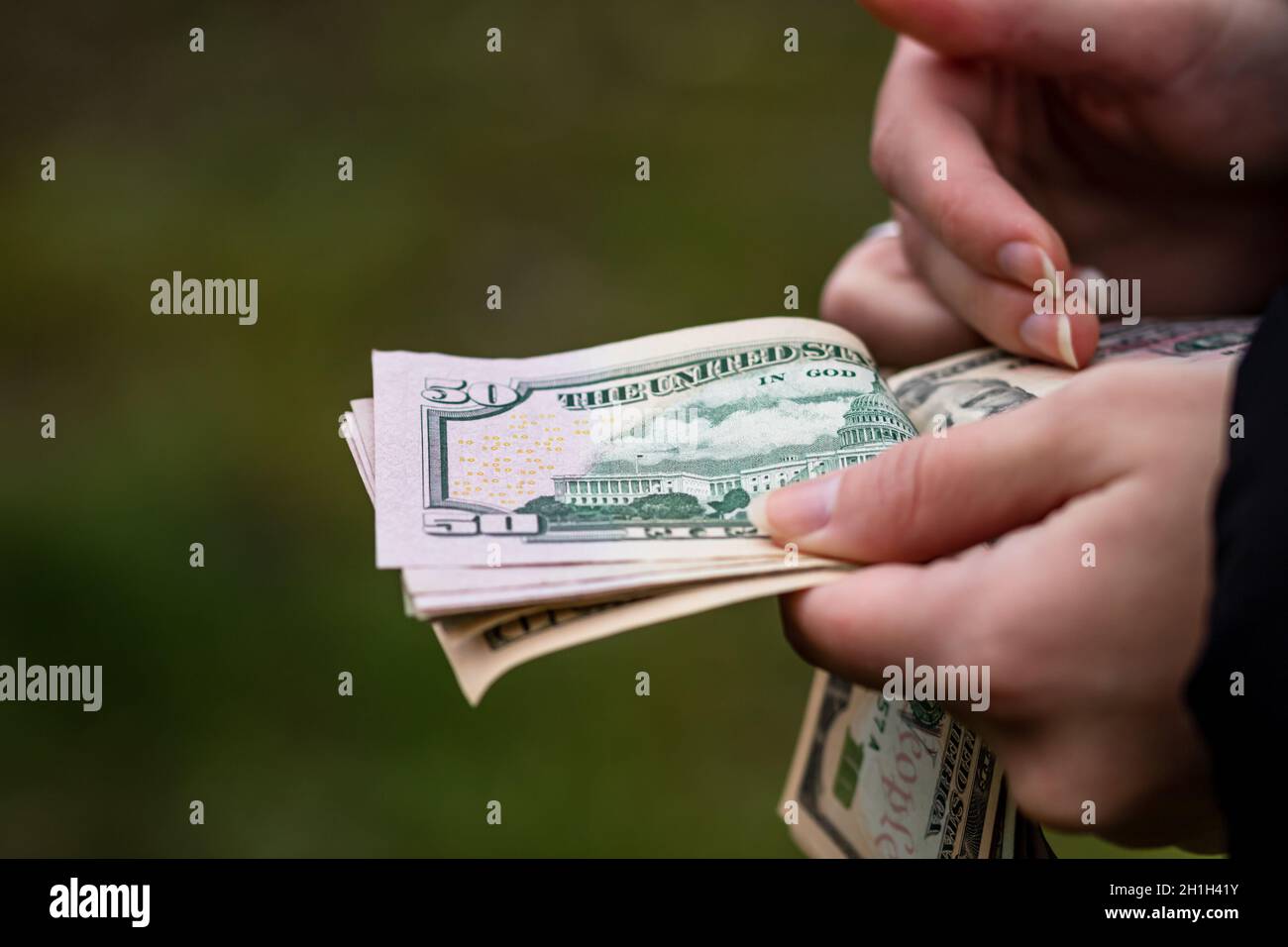 Selective focus on detail of USD banknotes. Counting or giving United ...