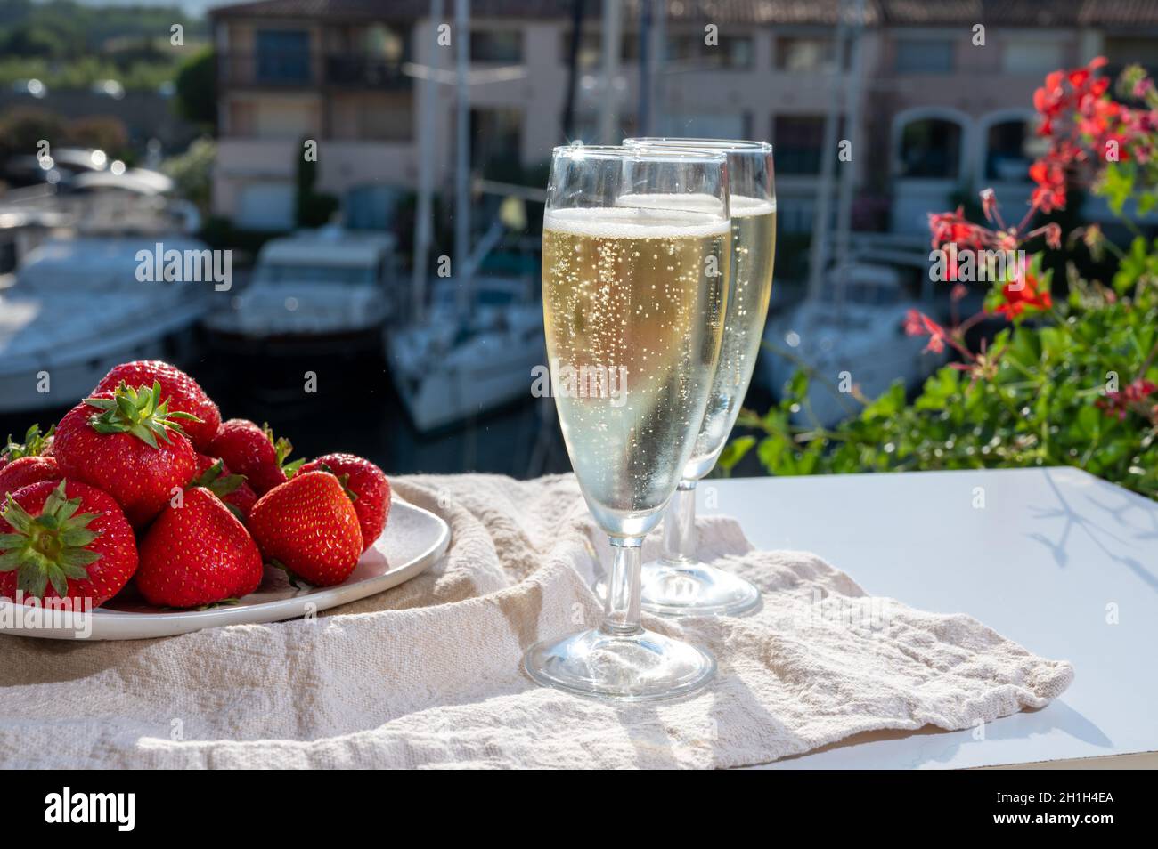 Summer party, pouring of French brut champagne sparkling wine in ...