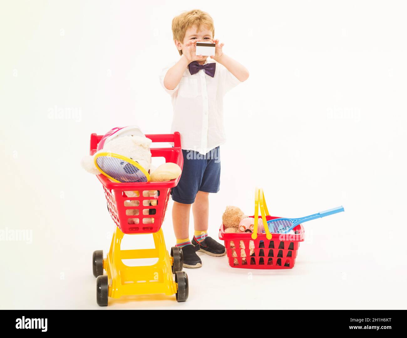 Child boy with credit card. Shopping, discount and sale. Happy little ...