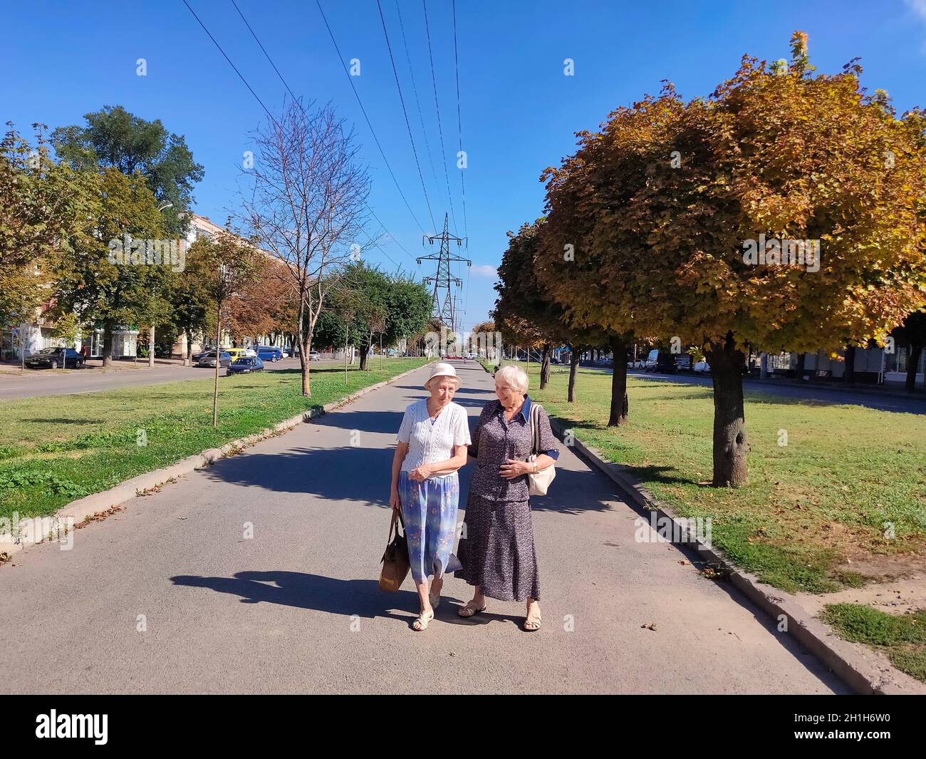 Two senior ladies going along City street. View of mature women at ...