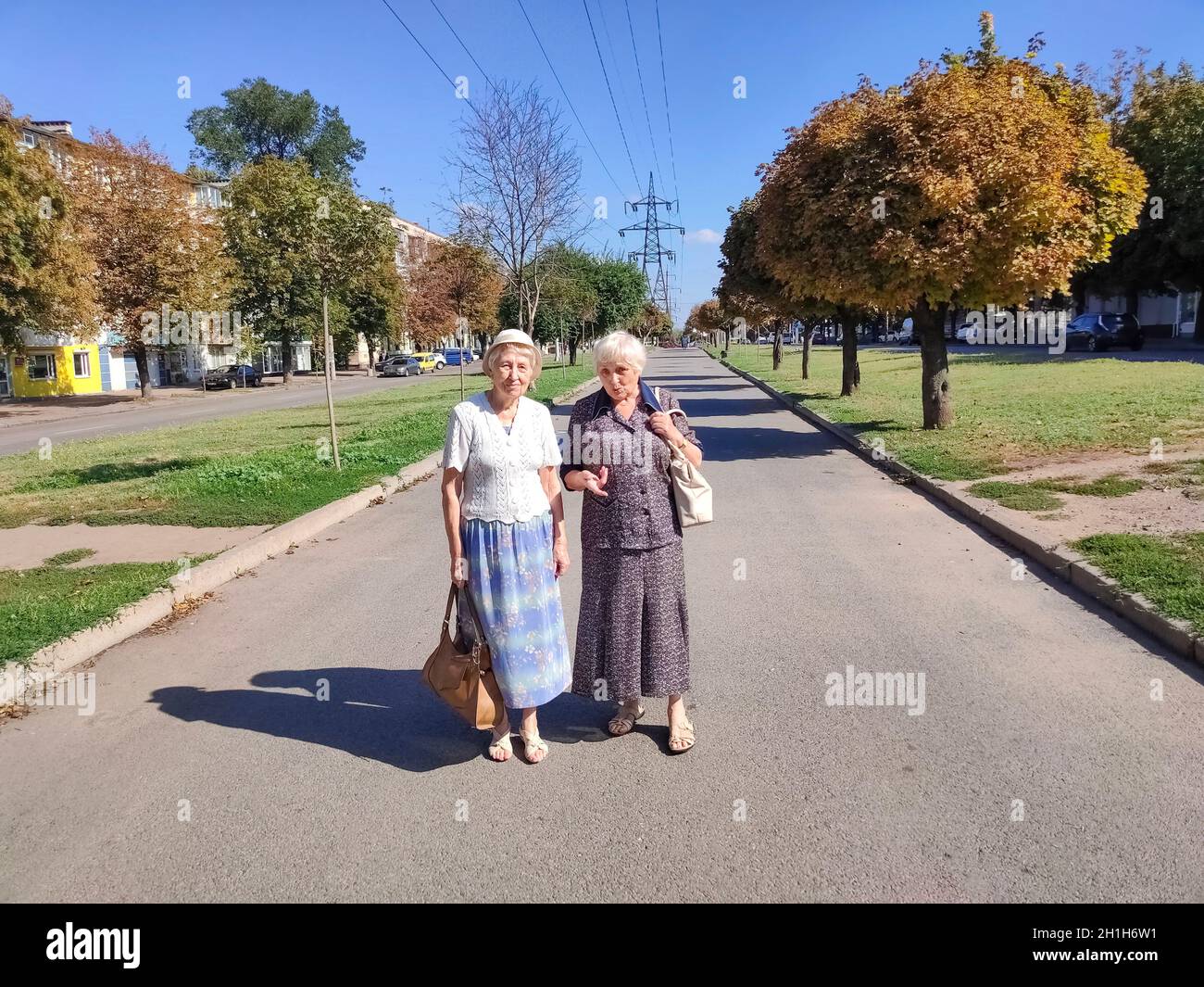 Two senior ladies going along City street. View of mature women at ...