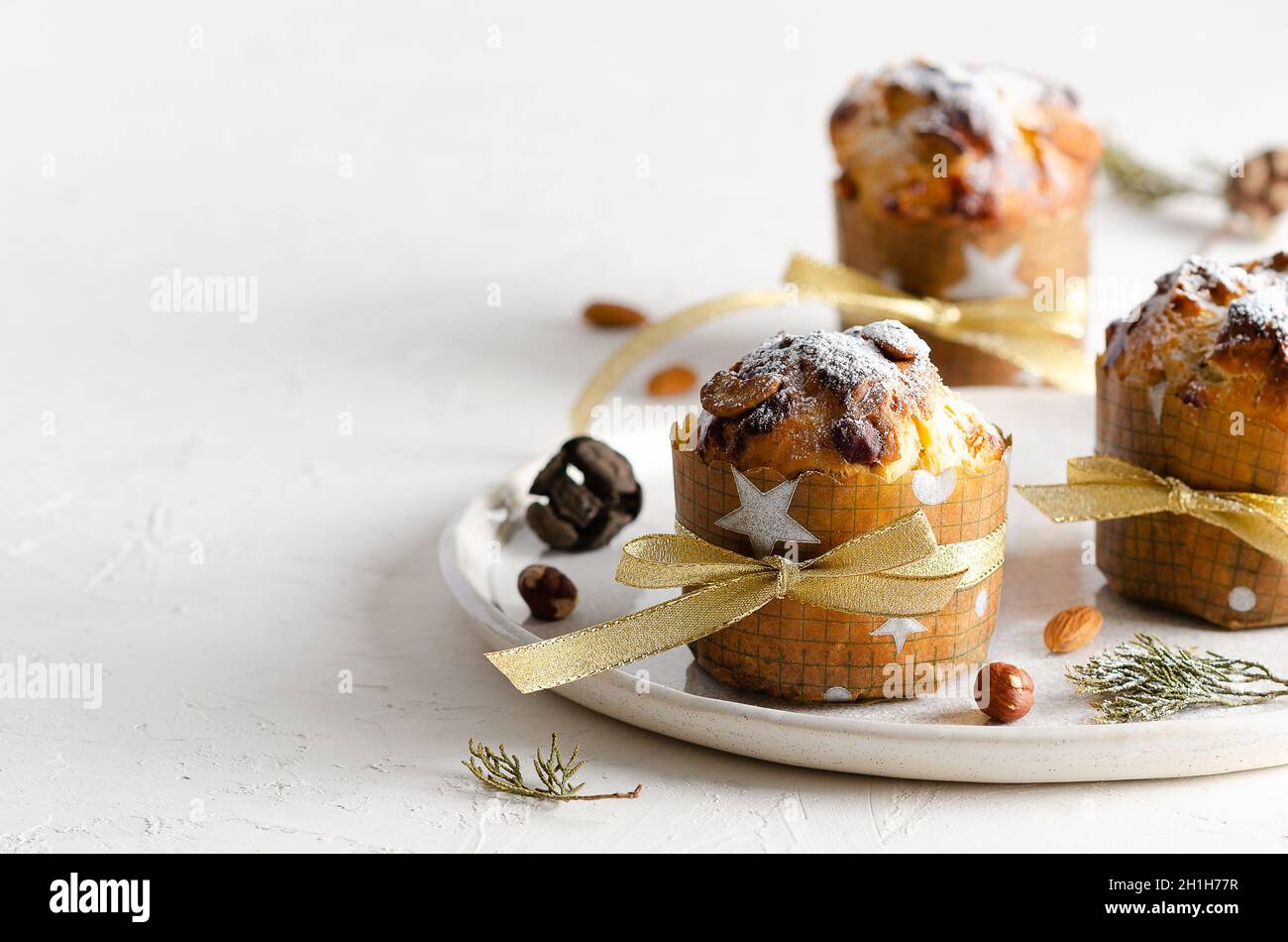 Mini panettone in a white plate on a white background Stock Photo - Alamy