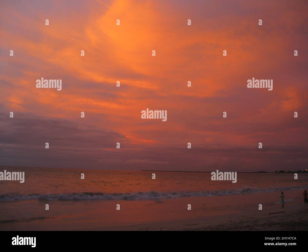 Image of the red sun setting over the ocean Stock Photo - Alamy