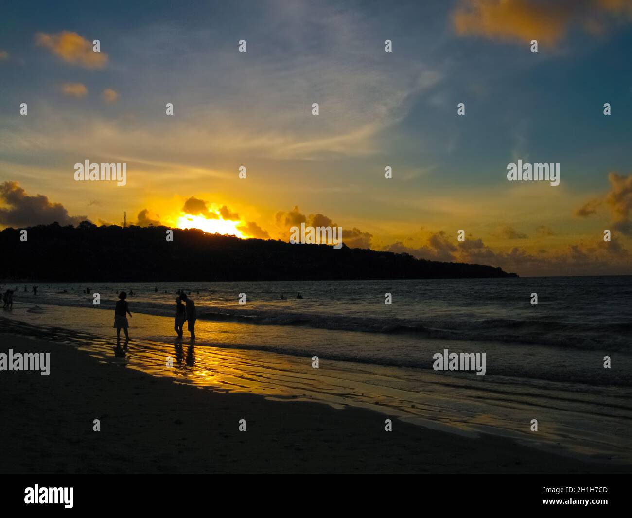 Image of the red sun setting over the ocean Stock Photo - Alamy