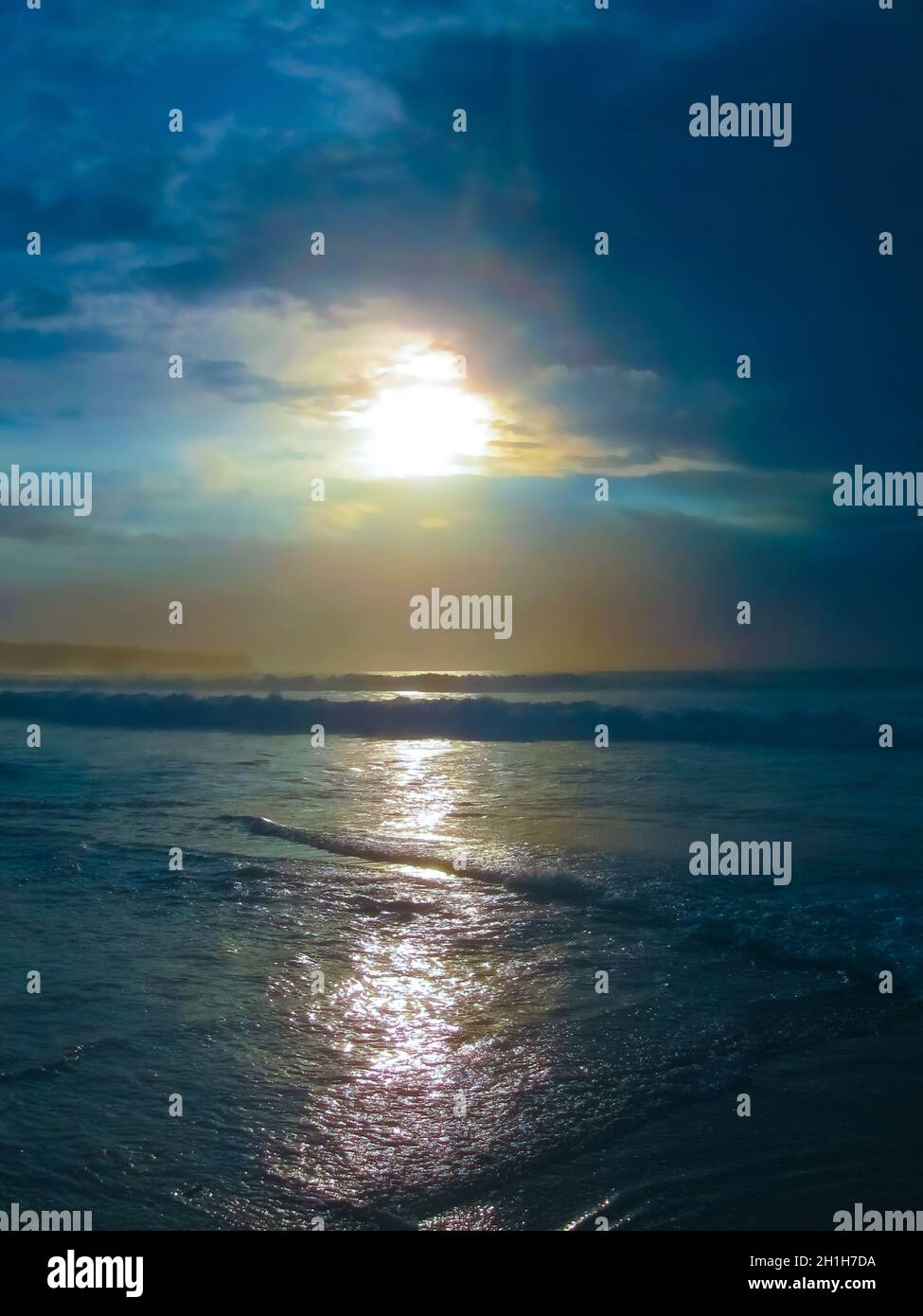 Image of the red sun setting over the ocean Stock Photo - Alamy