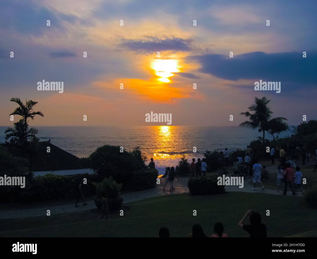 Image of the red sun setting over the ocean Stock Photo - Alamy