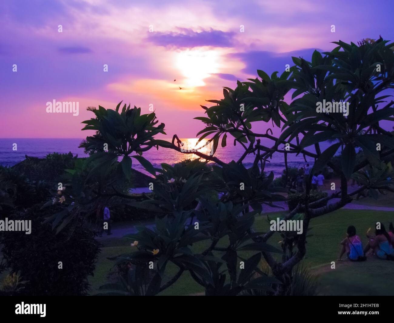 Image of the red sun setting over the ocean Stock Photo - Alamy