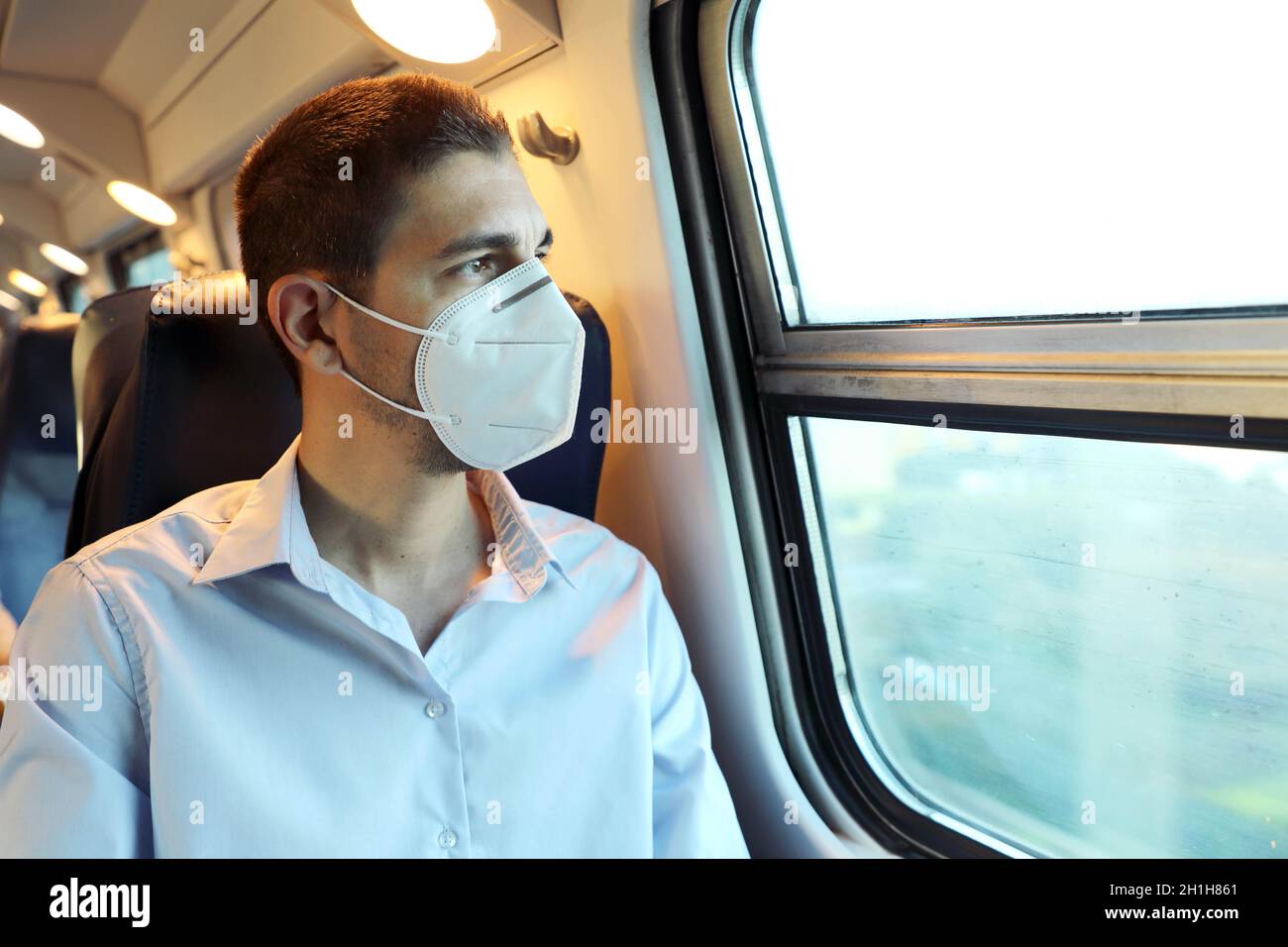 Travel safely on public transport. Young man with KN95 FFP2 face mask ...