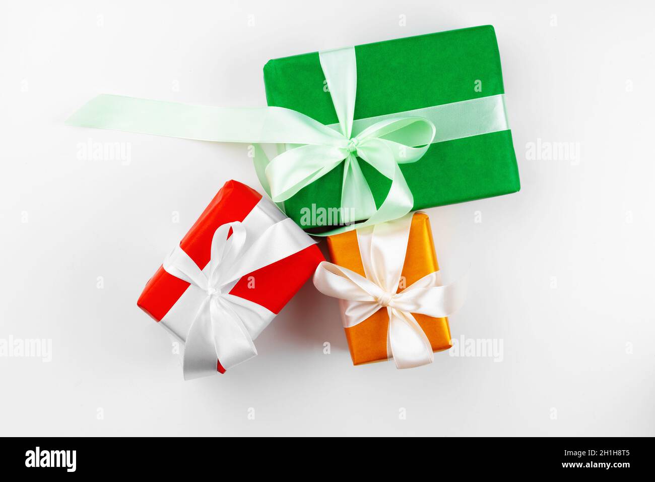 Three beautiful wrapped gifts isolated on white background Stock Photo ...