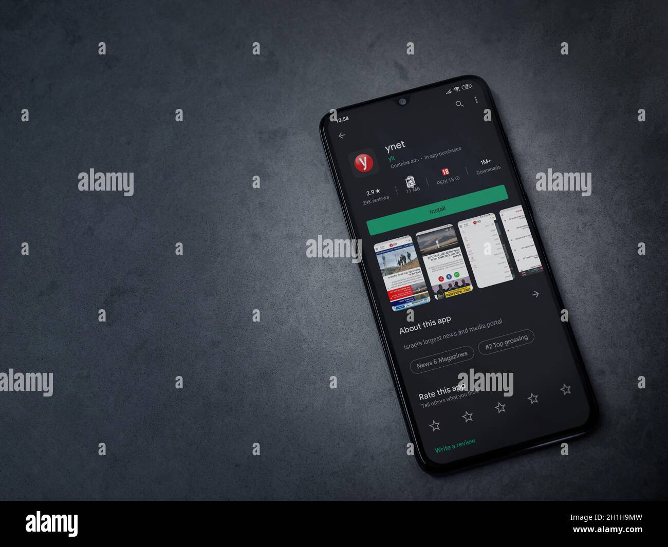 Lod, Israel - July 8, 2020: ynet app play store page on the display of a black mobile smartphone ...