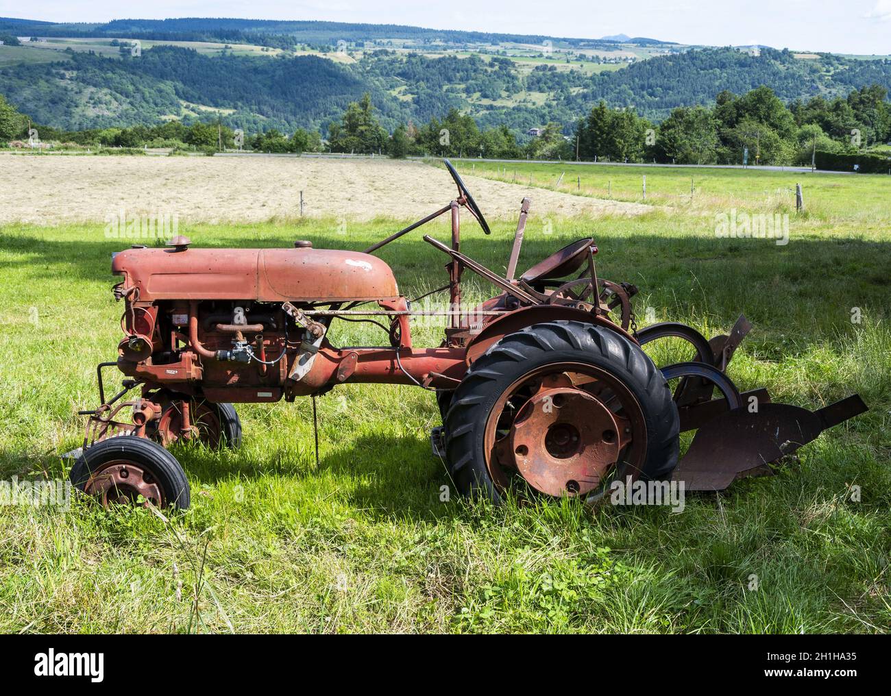 Small rusty tractor on a wildflower meadow Stock Photo - Alamy