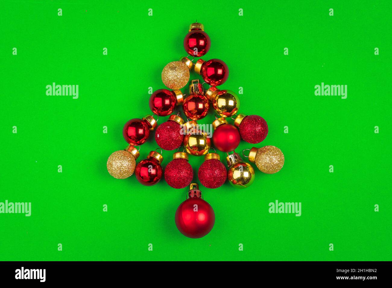 Christmas tree made with small baubles on green background Stock Photo ...