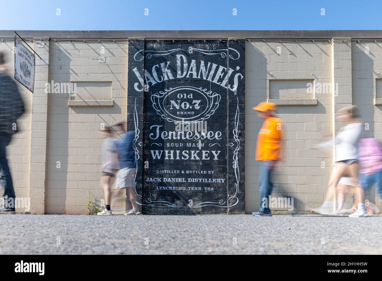 LYNCHBURG, UNITED STATES - Oct 10, 2021: People walk by a Jack Daniel's ...