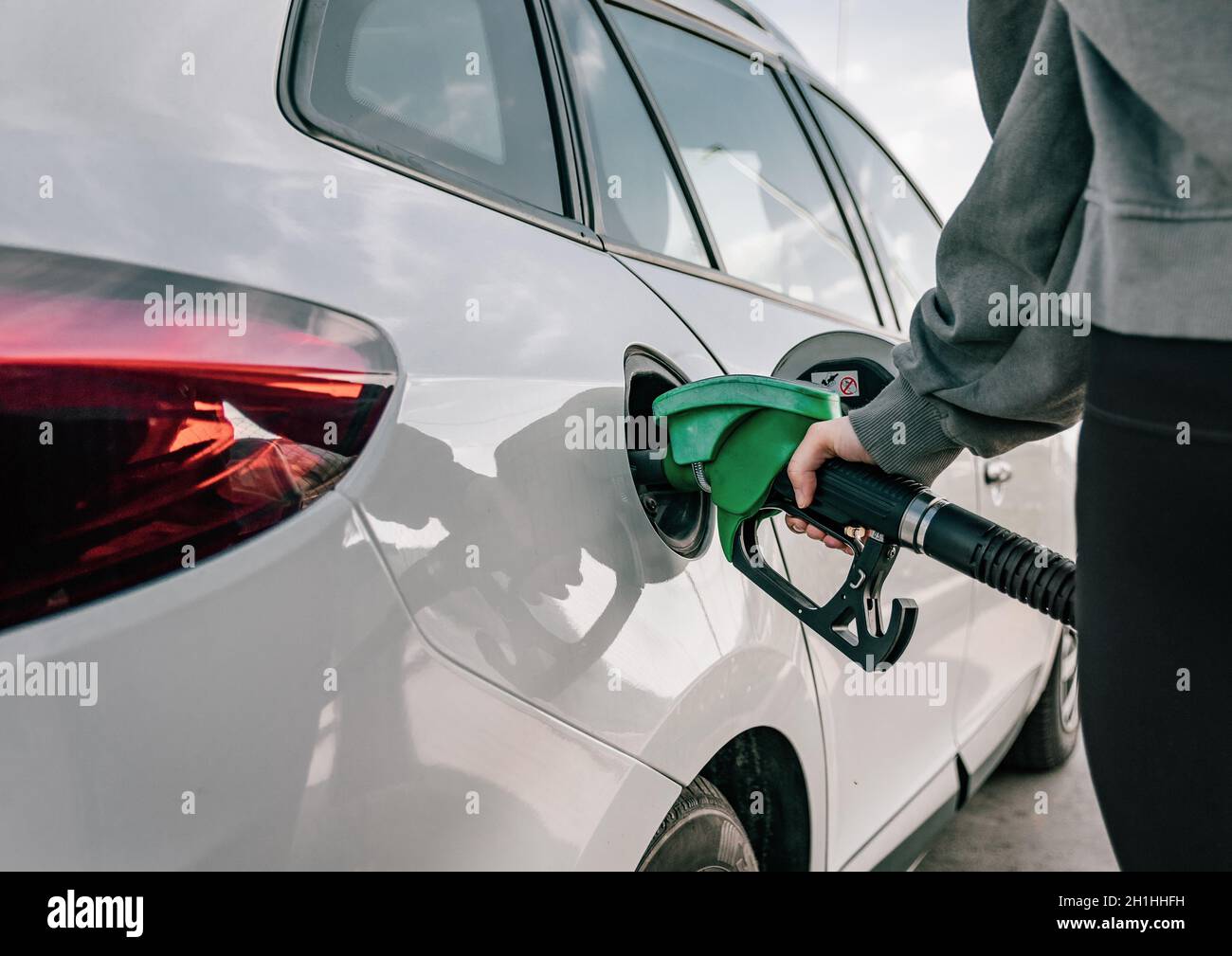 Hand refilling car with fuel at gas station Stock Photo - Alamy
