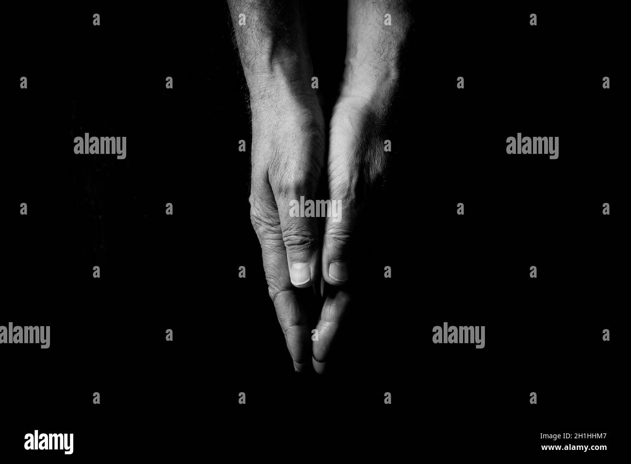 Black & white image of two male hands touching, palms pressed together ...