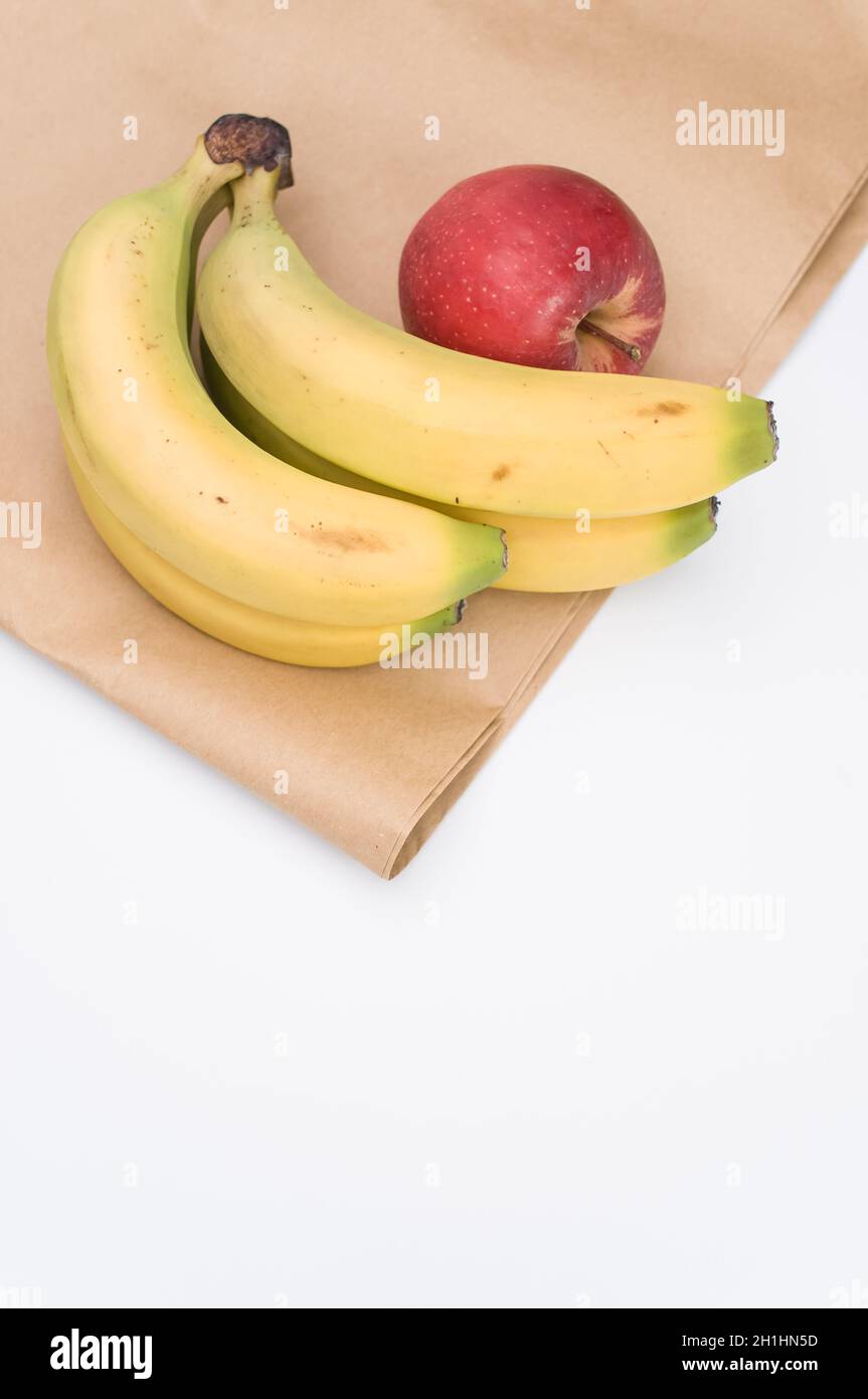 fresh organic agriculture apple and bananas fruit on a brown paper and ...