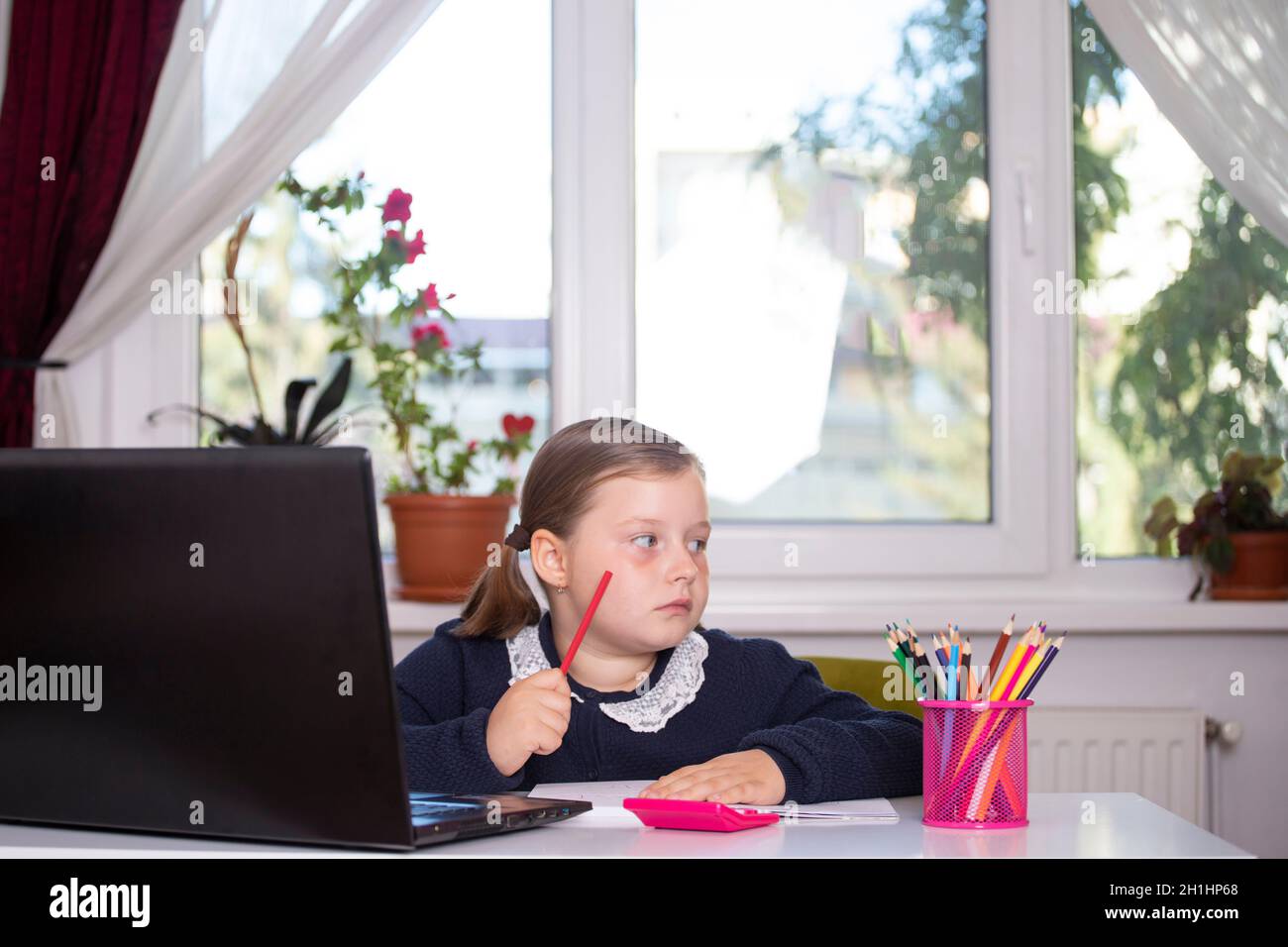 Distance learning-online education. School girl watching online ...