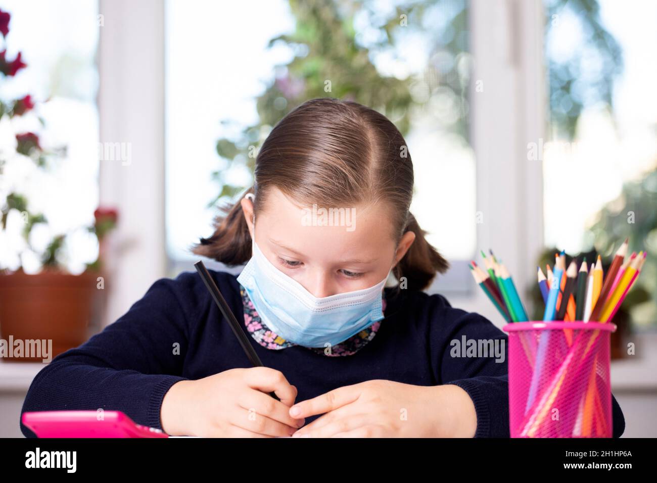 School child wearing mask for protection against coronavirus in school ...
